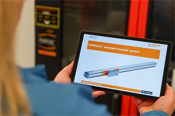 Tablet held by two hands and displaying a Renishaw encoders installation guide